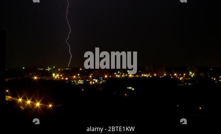 Lightning strikes down over the city at night. Long Exposure ...