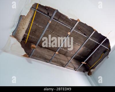 Broken and destroyed wooden ceiling with visible boards and missing ...