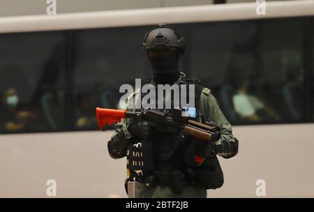 Riot police in full combat gear on standby in the town plaza during ...