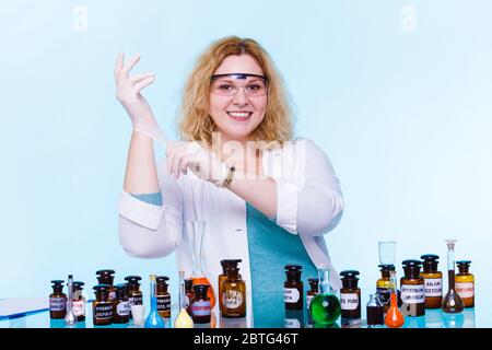 Experiment, research in progress. Chemist woman or student girl ...