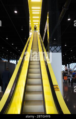 A person riding an escalator at The Seattle Public Library, Central ...