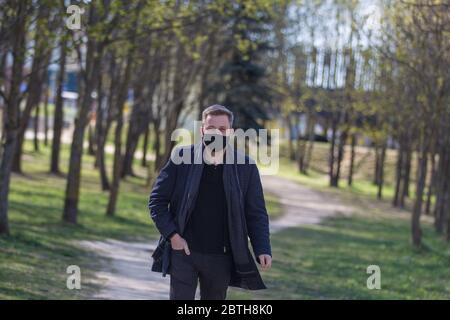 Masked a man walking in the park Stock Photo - Alamy