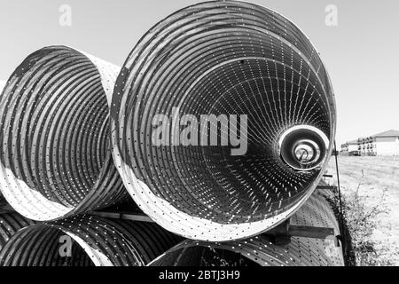 Perforated culvert stacked for use at a construction site in Modesto ...