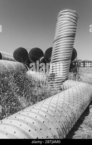 Perforated culvert stacked for use at a construction site in Modesto ...