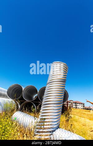 Perforated culvert stacked for use at a construction site in Modesto ...