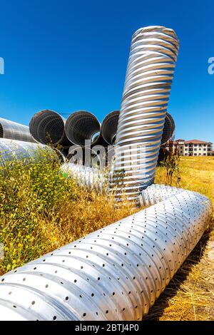 Perforated culvert stacked for use at a construction site in Modesto ...
