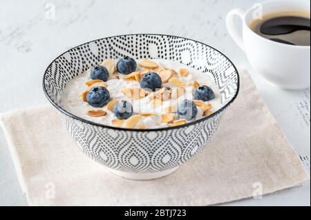 Portion of homemade Bircher muesli with cup of coffee Stock Photo - Alamy