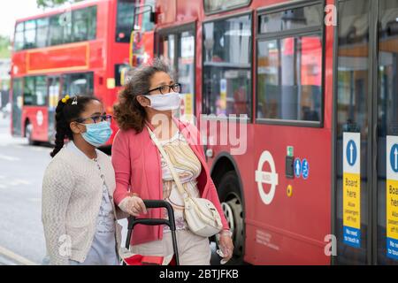 Commuters wear face coverings on London buses as they return to work ...