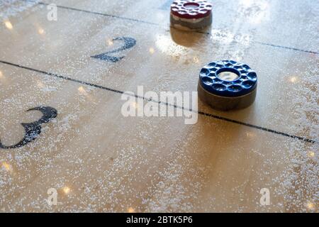 Pucks on a shuffleboard table Stock Photo - Alamy