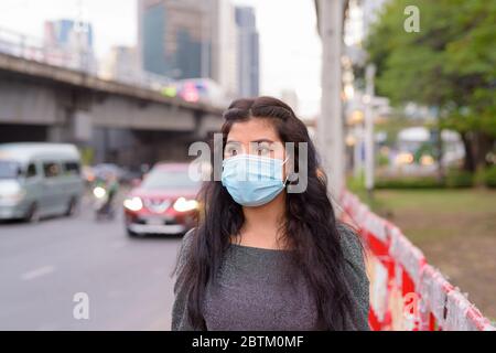 Indian female with a mask in the city on a sunny day Stock Photo - Alamy