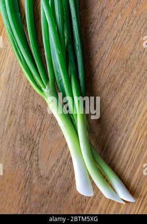 Bunch of green onion. Old rustic wooden table background Stock Photo ...