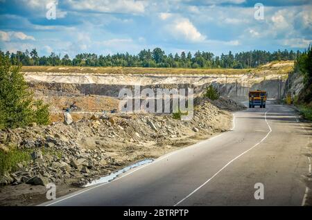 Zhodzina, Belarus - August 16, 2013: Granite mining in Quarry Trucks ...