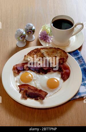 hearty breakfast plate two fried eggs sunny side up bacon strips toast ...