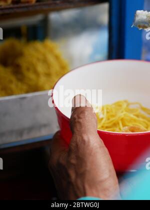 a mobile meatball seller is preparing a buyer's order Stock Photo - Alamy