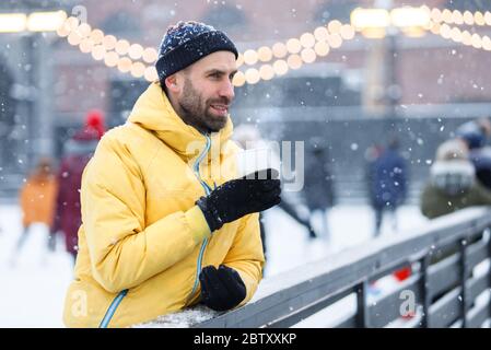 Caucasian man with beard holding thermo smiling happy pointing with ...