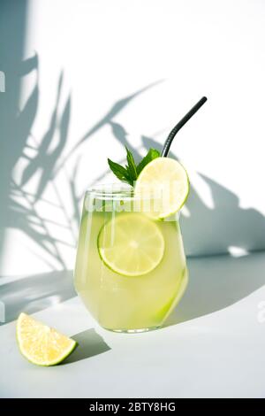 Fresh drink with lime on a sunny day outside Stock Photo - Alamy