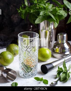 Mojito Cocktail Making. Mint, Lime, Ice, Glass and Bar Shaker on Dark ...