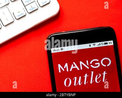 In this photo illustration a Mango Outlet logo seen displayed on a ...