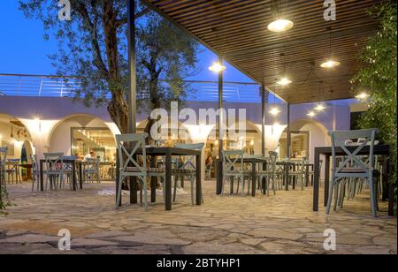 Terraced dining area at dusk at the Marbella Beach Hotel, Corfu, Greece ...
