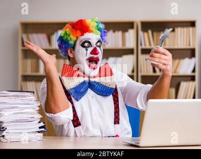 Clown businessman working in the office frustrated commiting suicide ...