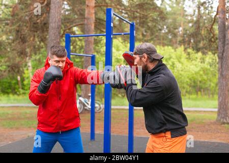 Male caucasian middle age boxer training outside in nature. Nice sunny ...
