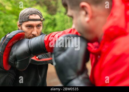 Male caucasian middle age boxer training outside in nature. Nice sunny ...