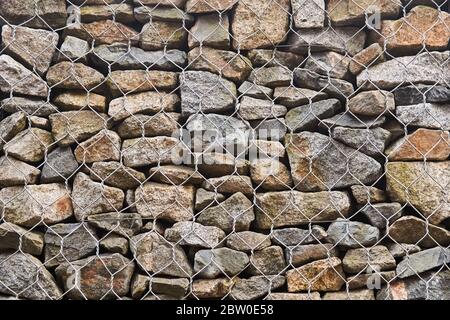 Gabion wire mesh wall. A hexagonal steel cages formed with the purpose ...
