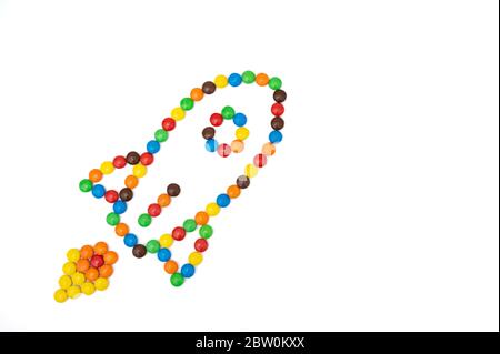 Rocket shape made of colorful candies on white background Stock Photo ...