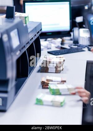 Sorted banknotes placed on the table after it is counted on the ...