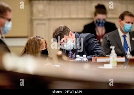 A military aide speaks to United States President Donald J Trump during ...