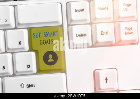 Writing note showing Set Smart Goals. Business concept for list to ...