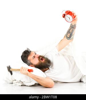 young man tries to break the alarm clock with hammer Stock Photo - Alamy