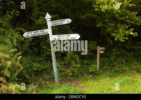 Traditional rural English road sign pointing toward Corfe Castle ...