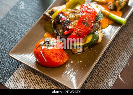 beautiful serving of baked various vegetables on plate in cafe Stock ...