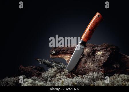 Hunter combat hand made knife and broken stones. The blade has a ...