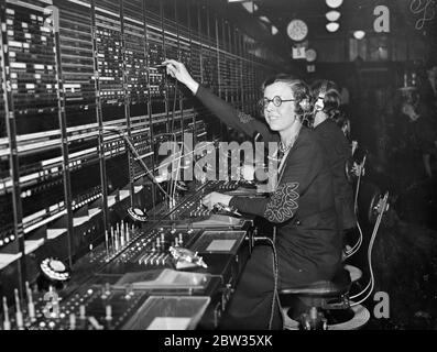 1930s WOMAN TELEPHONE OPERATOR AT SWITCHBOARD LOOKING AT CAMERA SMILING ...