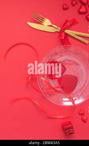 Valentines day dinner background with gifts, red hearts, fork and knife ...