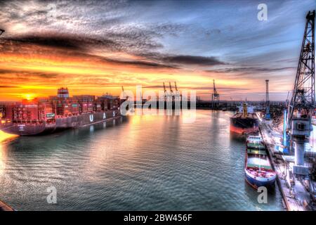 City of Southampton, England. Artistic sunset view of a container ship ...