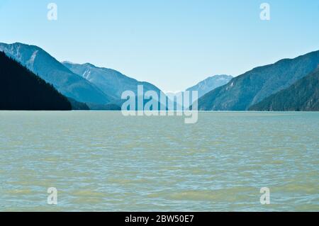 The mountain fjords and glacial river fed waters of Owikeno Lake, in ...