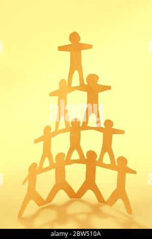 Human team pyramid supporting each other Stock Photo - Alamy