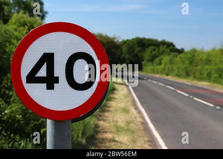 40 mph speed limit sign on country road named as a quiet road with ...