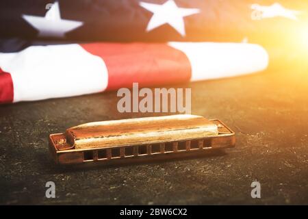 Harmonica on background of the flag of the United States of America ...