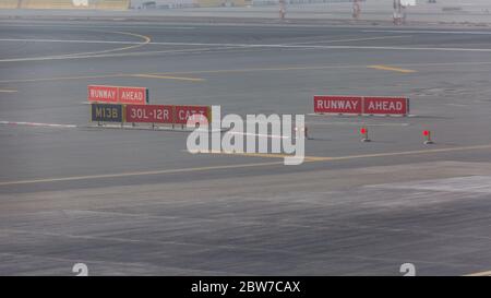 Directional sign markings on the tarmac of runway at a commercial ...