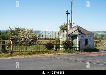 An old level crossing gate on the former M&GN railway track at Stock ...