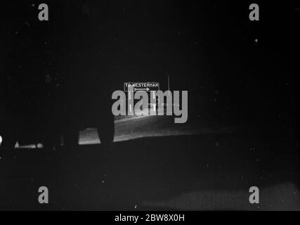 Westerham road sign lit up at night . 1936 Stock Photo - Alamy