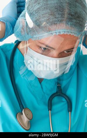 close up. doctor putting on a protective mask Stock Photo - Alamy
