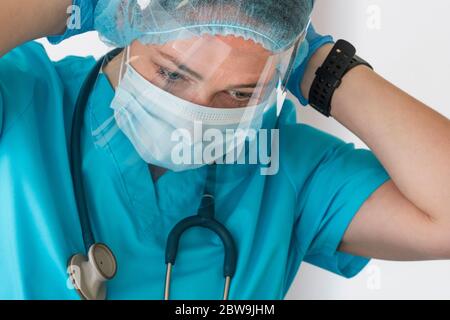 Nurse putting on face shield Stock Photo - Alamy