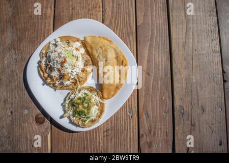 top view of variety of antojitos mexicanos like tacos, enchiladas ...