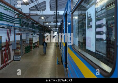 Corridor of the maintenance hall, subway train parked on pit for ...