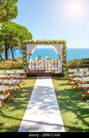 Beautiful wedding by the ocean on a sunny day. Arch cleaned with ...